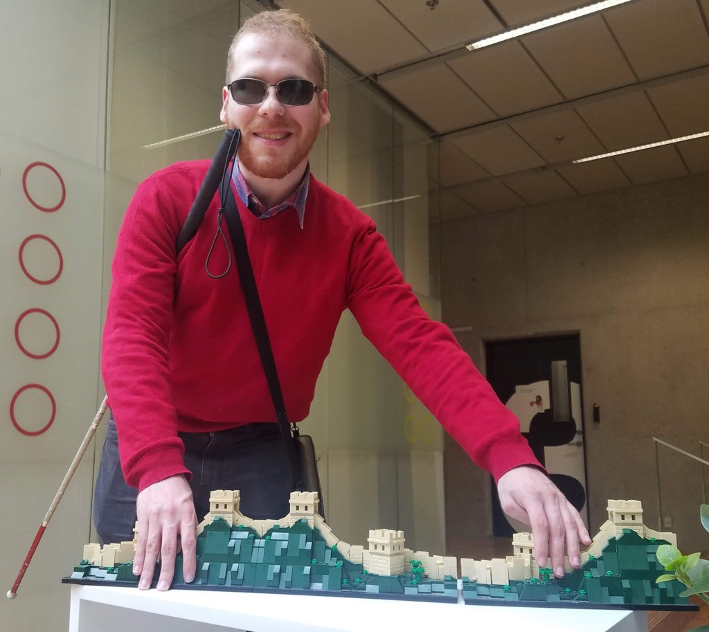 Blind guy travels … and sings, and plays accordion, and makes Legos ...